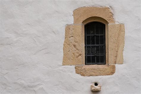 Lonely Behind A Lattice Window In A White Plaster Wall Stock Image