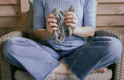 Woman In Jeans Holding Ball Of Grey Yarn Girl Sitting In Armchair With