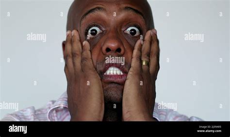 Neurotic Anxious Black African Man Looking At Camera In Desperation And