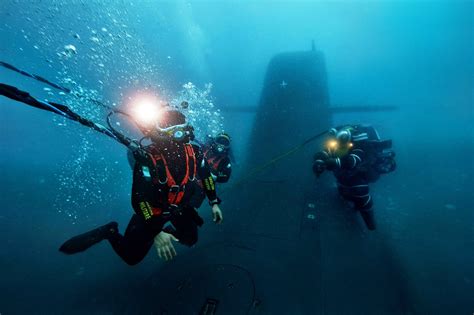 Divers Assisting A Submarine Escape During Operation Dynamic Monarch