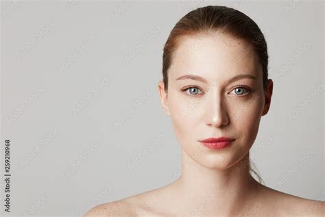 Beauty Portrait Of A Pretty Young Topless Redhead Girl With Freckles Isolated Over White