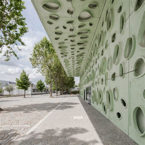 Perforated green cladding wraps science university by Cláudio Vilarinho