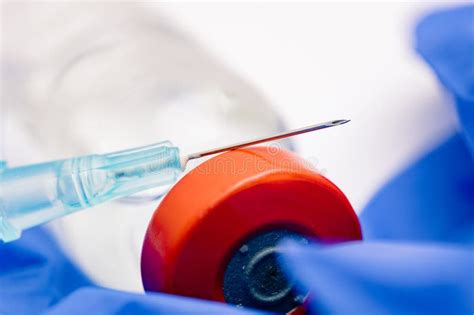 Vaccine And Vaccination Concept 24 Gauge Syringe With Red Top Vial