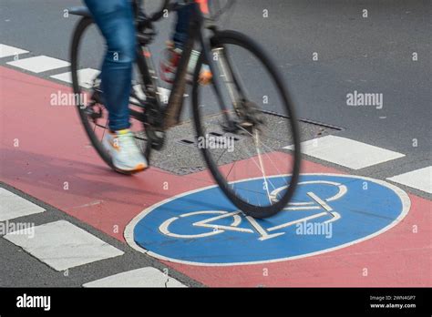 Blurred Bicycle On A Cycle Path With A Blue Cycle Path Symbol Stock