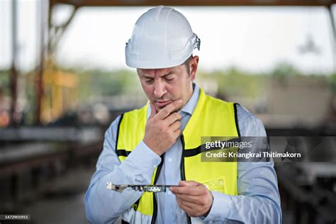 An Engineer Is Checking Electrical Circuit Model At Factory High Res