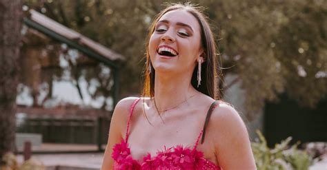 Young Woman In An Elegant Pink Dress Standing Outside And Smiling
