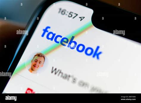 iphone with open facebook app social network app icon display on