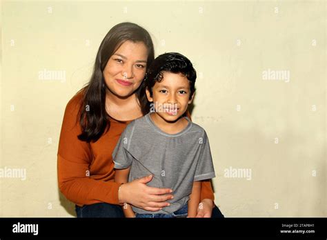 Latino Mother And Son Playing Making Faces Having Fun Playing Being