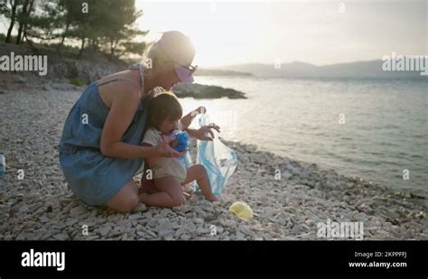 Girl Throws Plastic In The Trash On The Beach By The Sea Stock Video