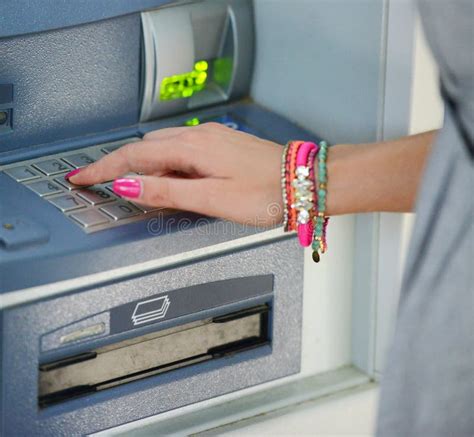 close up of hand entering pin pass code on atm bank machine keypad