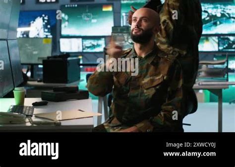Military Agent Using Augmented Reality Tech In Control Room Analyzing Aerial Reconnaissance