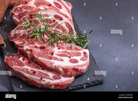 Raw Pork Neck Meat Chop Steak Red Peppercorn Garlic Cloves Sea Salt