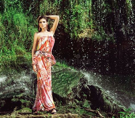 Beautiful Slim Fitness Model Posing In Front Of Waterfalls Stock Image