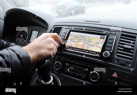 A Man Operates His Navigation System While Driving In His Car In Munich Germany 30 March 2013