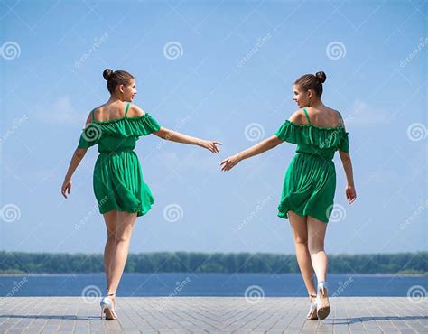 Young Beautiful Brunette Girl In Green Dress Walks Along The Embankment