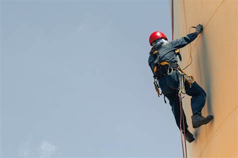 두께 저장 오일 및 가스 탱크 산업의 남성 작업자 로프 접근 높이 안전 검사 프리미엄 사진
