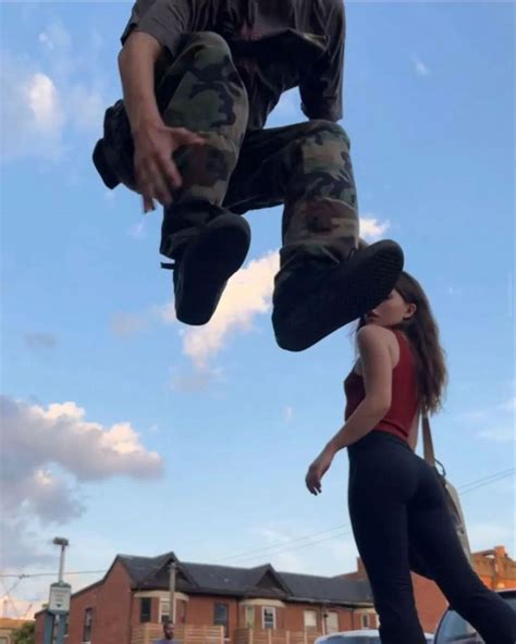 Two People Are Doing Tricks On Skateboards In The Air While Another
