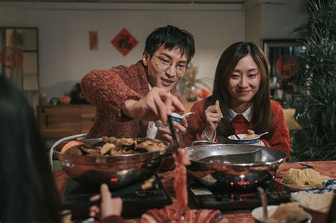 중국 설날 가족 상봉 저녁 식사에서 즐기는 중국 젊은 커플 집에서 가족 상봉 저녁 식사를하는 홍콩 다세대 가족 가정 생활에 대한