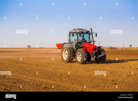 Farmer Fertilizing Arable Land With Nitrogen Phosphorus Potassium