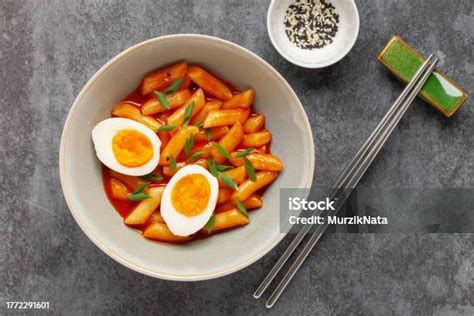 회색 그릇에 계란을 곁들인 떡볶이 떡볶이는 떡을 곁들인 한국 요리입니다 아시아 음식 평면도 복사 공간 Gochujang에 대한