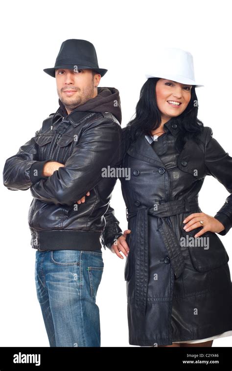 Fashionable Couple Wearing Leather Jackets And Hats Isolated On White