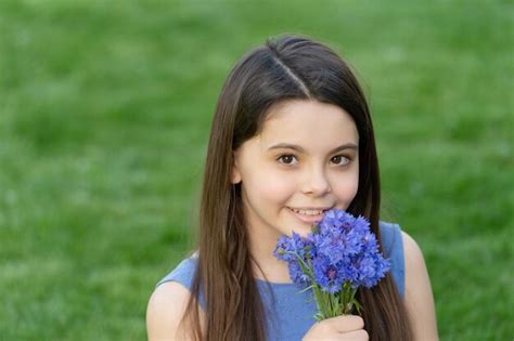 Premium Photo Smiling Teen Girl Smelling Flowers Pretty Girl On Grass
