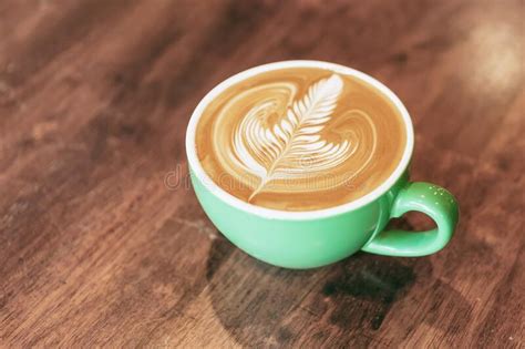 Hot Latte Art Coffee Cappuccino In A Cup On Wooden Table Background