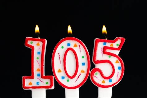 Premium Photo Colorful Burning Birthday Candle On Dark