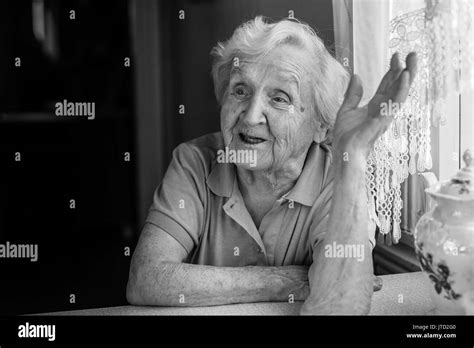 Black And White Portrait Of An Elderly Woman Emotional Says In Her Home