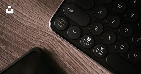 Black And White Keyboard On Brown Wooden Table Photo Free Computer Image On Unsplash