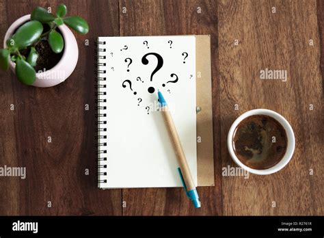 Question Mark Symbols In Notebook Laying On Office Desk Flat Lay View