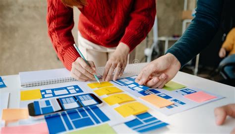 Ux Developer And Ui Designer Brainstorming About Mobile App Interface