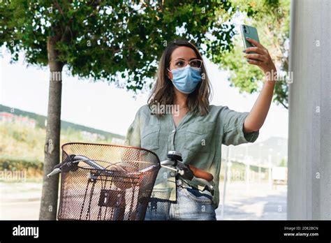 Young Girl With Glasses And Mask Making A Selfie While Riding A Hipster