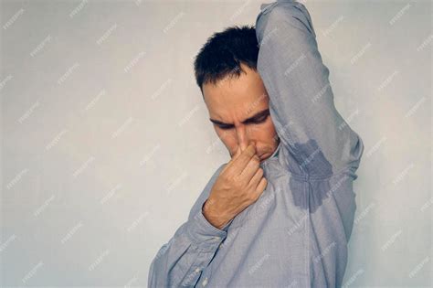 Premium Photo Closeup Portrait Young Man Smelling Sniffing Armpit
