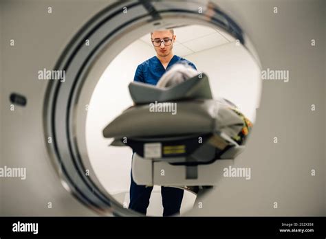 Through The Opening Of A Ct Scanner A Medical Professional Is Seen