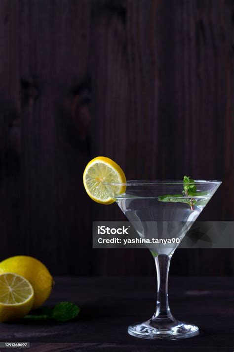 블랙 배경에 칵테일과 얼음마티니 유리 나무 테이블에 라임과 녹색 민트칵테일 마가리타 복사 공간을 복사합니다 알코올 음료 수직 0