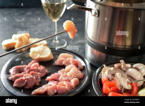 Hot Oil Fondue With Pieces Of Meat And Vegetables To Be Fried In A Pot