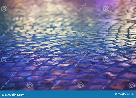 Cobble Stone Pavement Reflexion In Urban Night Wet Blue Sidewalk