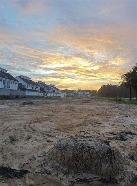 An Empty Plot Of Land Scene Besides A Residential Row Of Houses Stock