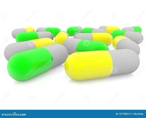 Green And Yellow Capsules Of Medicine On White Background Stock