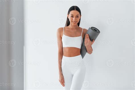 With Mat In Hands Young Caucasian Woman With Slim Body Shape Is