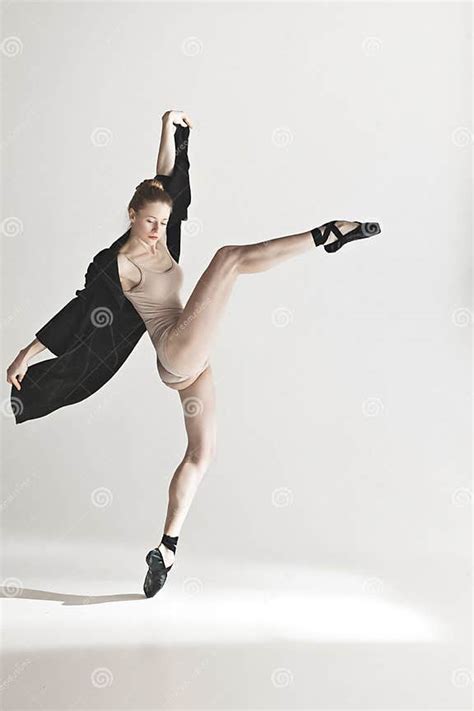 Young Beautiful Dancer In Beige Swimsuit Dancing On Gray Background