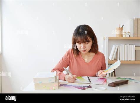 A Woman Studying Using A Color Chip Stock Photo Alamy