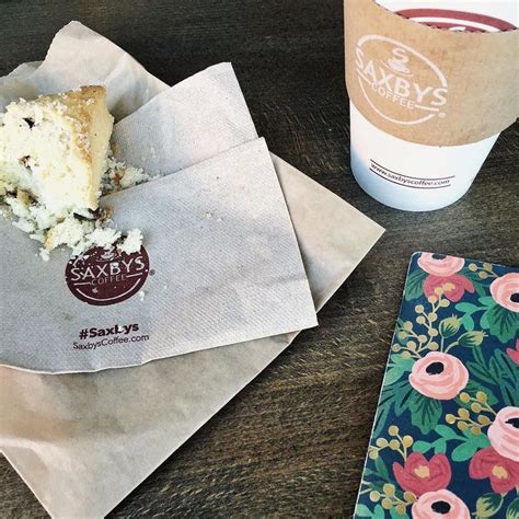 A Piece Of Cake Sitting On Top Of A Napkin Next To A Cup Of Coffee