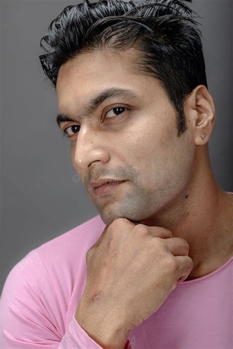 Cheerful Young Male Model In Casual Wear Wearing Pink T Shirt And Blue