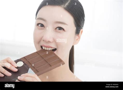 Asian Eating Chocolate Hi Res Stock Photography And Images Alamy