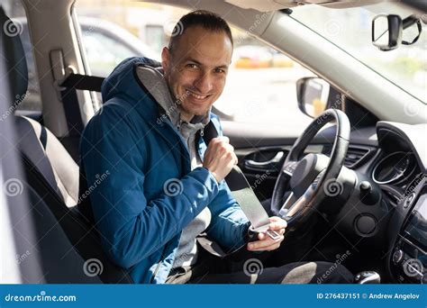 Young Latin Man Sitting On Car Seat Fastening Seat Belt Stock Image