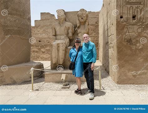 Tourist Couple Before The Statue Of The God Amun Re And His Wife Mut