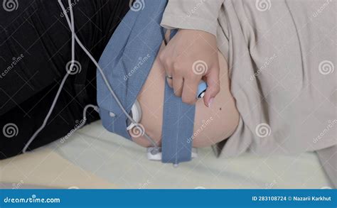 Woman Pregnant Checking Fetal Heart Beat By Fetal Monitoring Expectant Mother With Midwife
