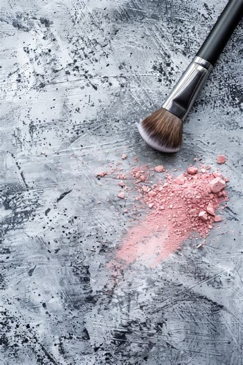 A Black Makeup Brush With Its Bristles Coated In Orange Powder Stock
